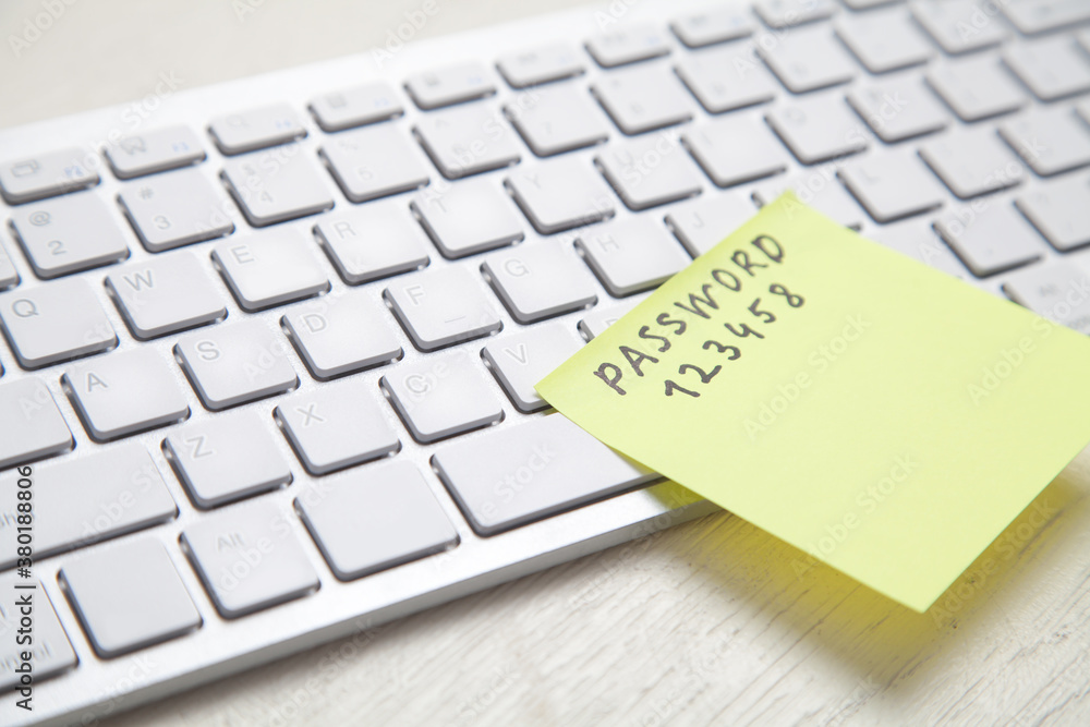 Password message written on sticky note in computer keyboard. Stock ...