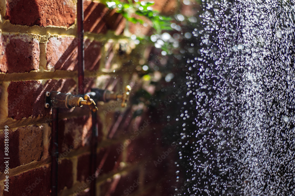 Water runing from an outdoor shower in sunlight Stock Photo | Adobe Stock