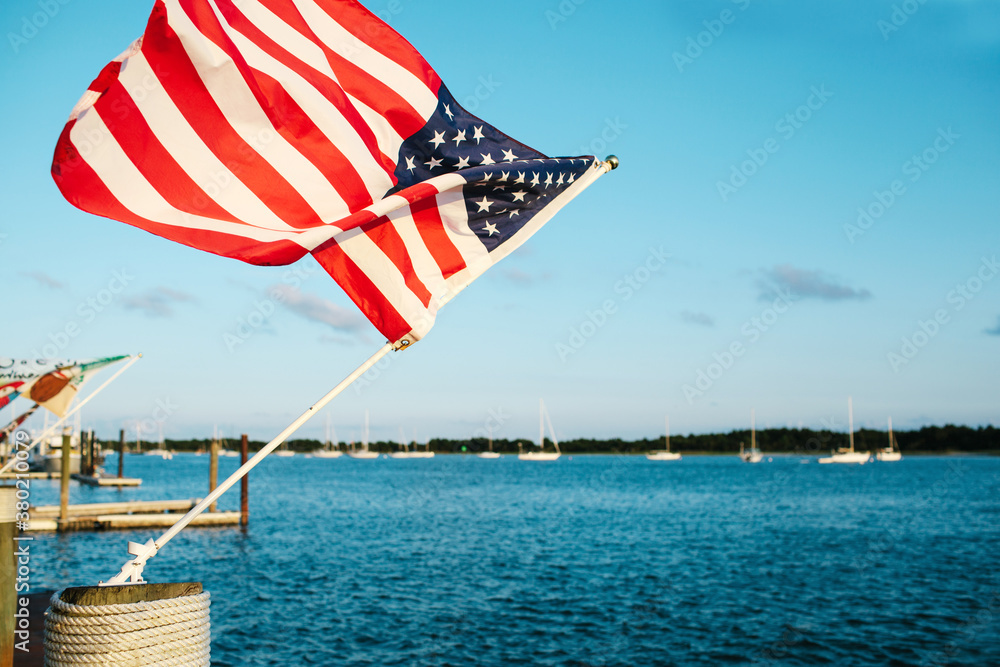 american flag flying over water Stock Photo | Adobe Stock