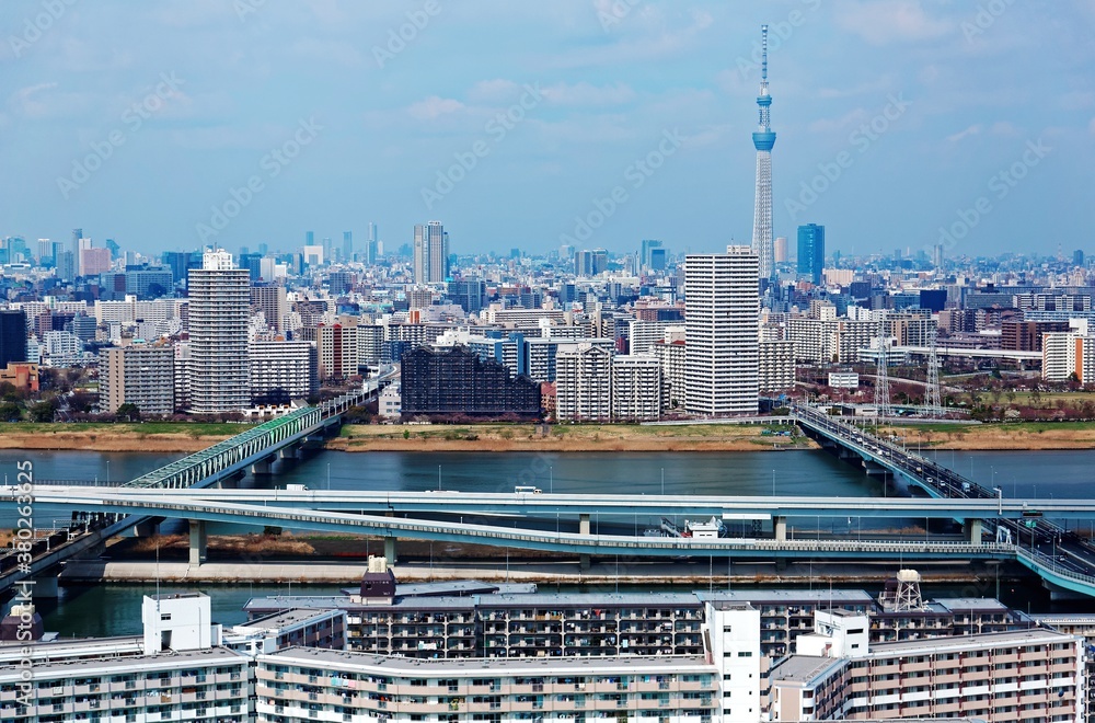 A panoramic view of Tokyo City skyline under sunny sky, with bridges ...