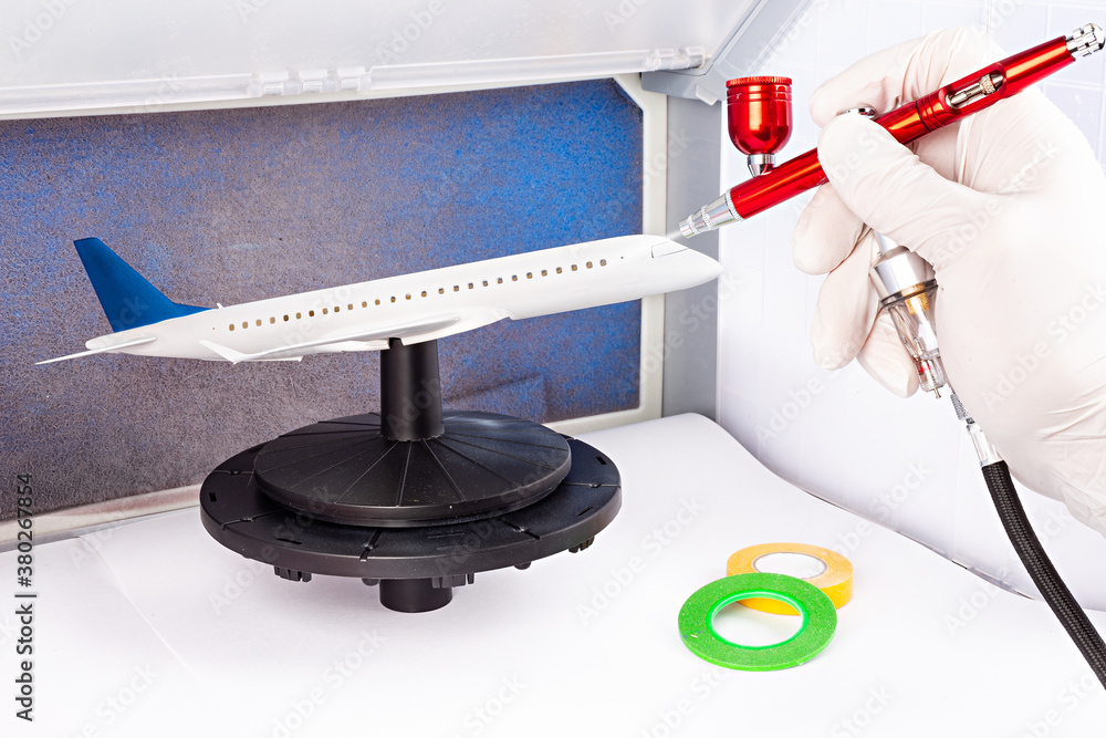 paint job with red metal airbrush spray paint gun on red scale model ...