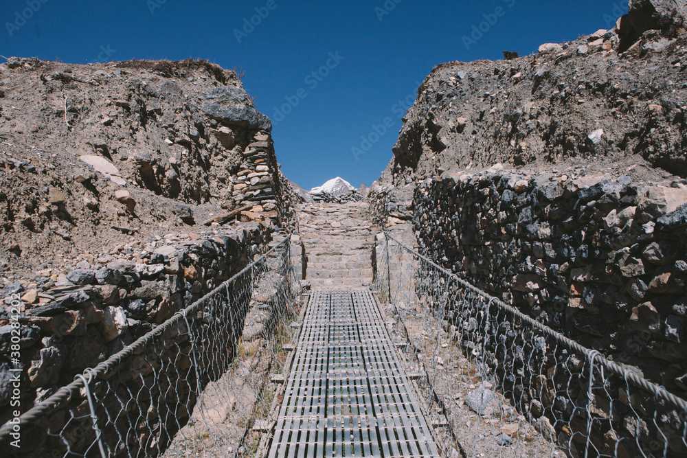 Suspension bridge on the Annapurna Circuit with the tip of Mount ...
