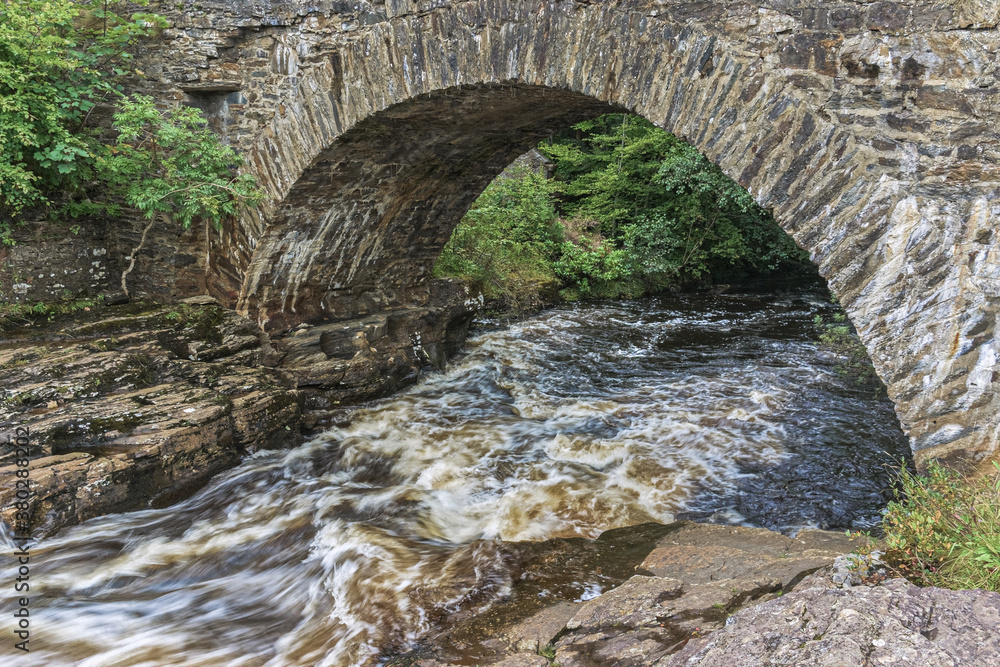 The old Bridge of Dochart, where the River Dochart flows through the ...