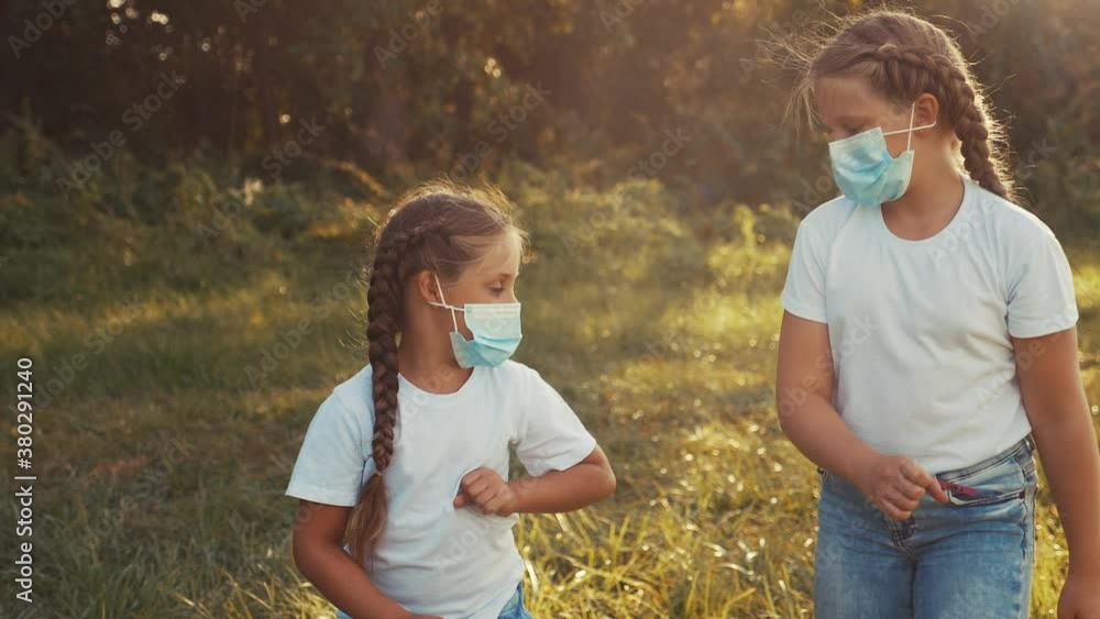 Vídeo do Stock: kids in the park touch social distance with their ...