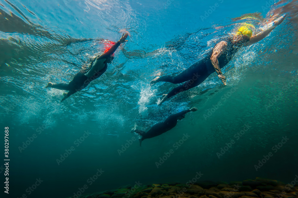 Triathlon Race Athletes Approach Finish of Swim Stage from Underwater ...