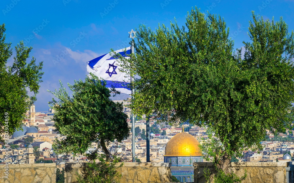 Olive trees and Israeli flag on the Mount of Olives lookout, with the ...