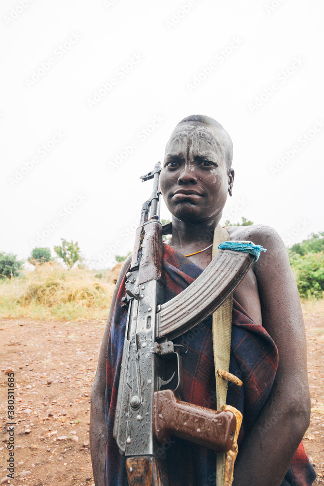 Mursi tribe African man with AK47 rifle. Mago National Park, Ethiopia ...