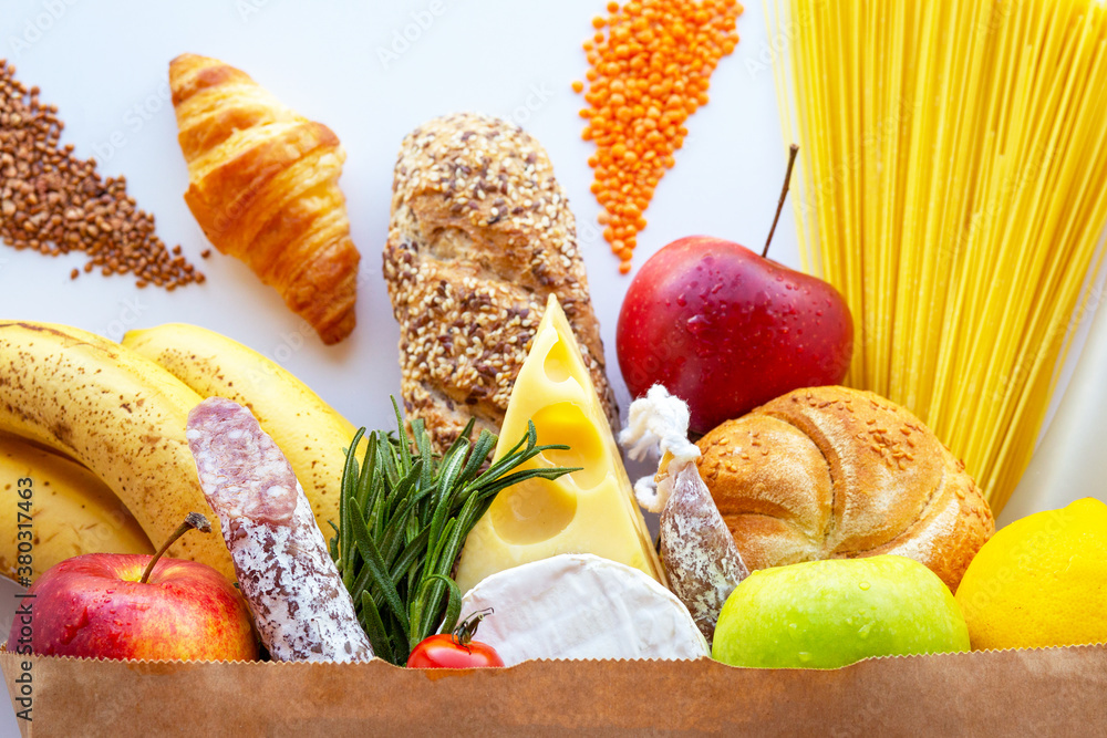 Full paper bag with healthy food.Supermarket food concept.Cheese, bread ...