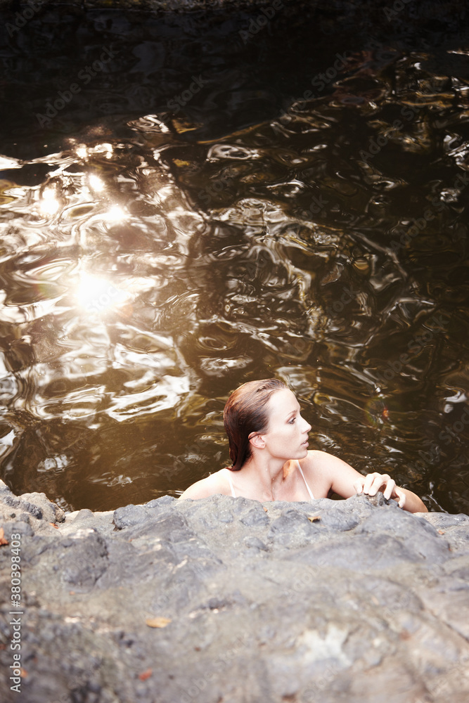 Beautiful redhead woman floating in water Stock Photo | Adobe Stock