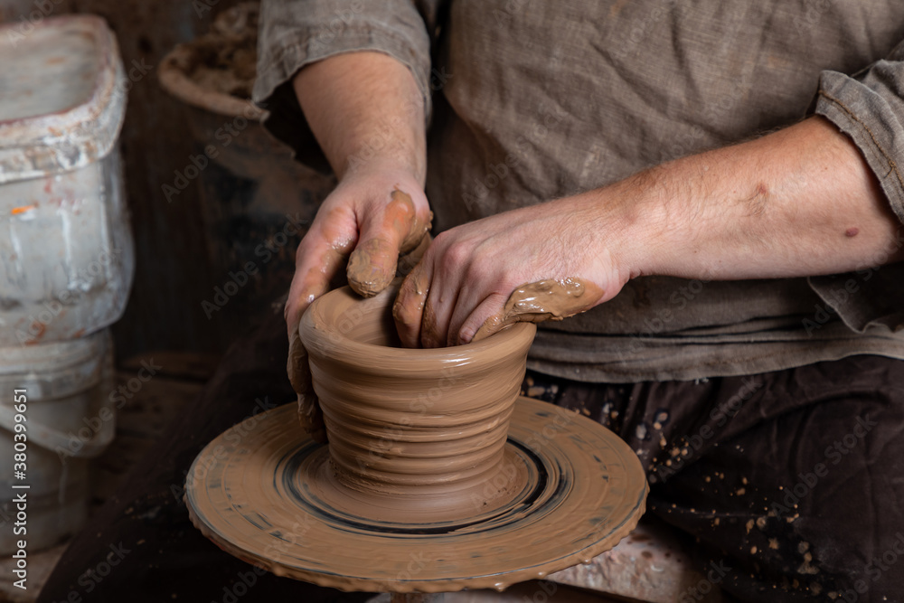 Creating a pot of clay close-up. Hands making products from clay ...