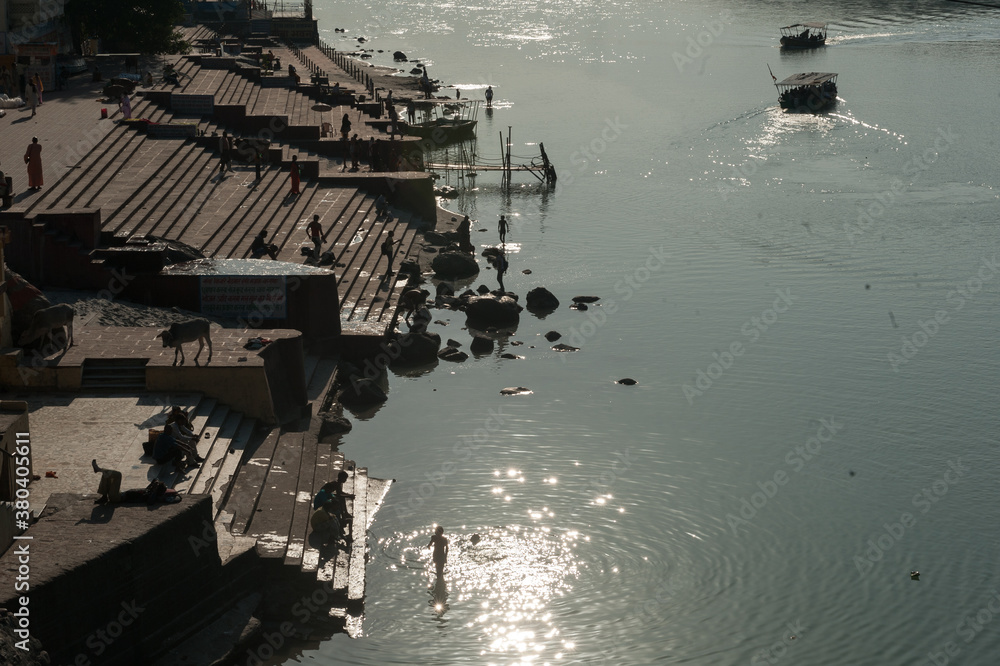 People performing a ritual bath in the holy river of Ganges believing ...
