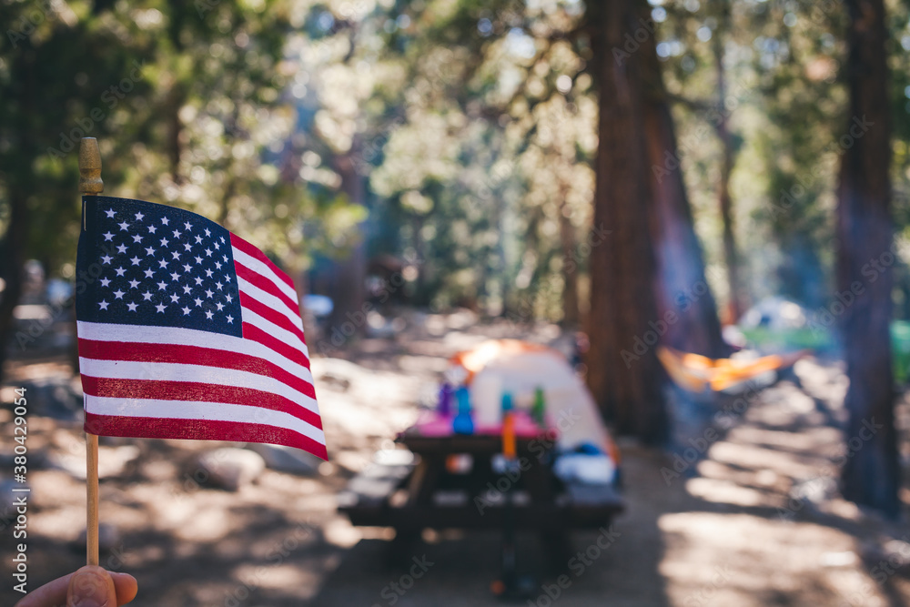 American flag in forest campground. Stock Photo | Adobe Stock