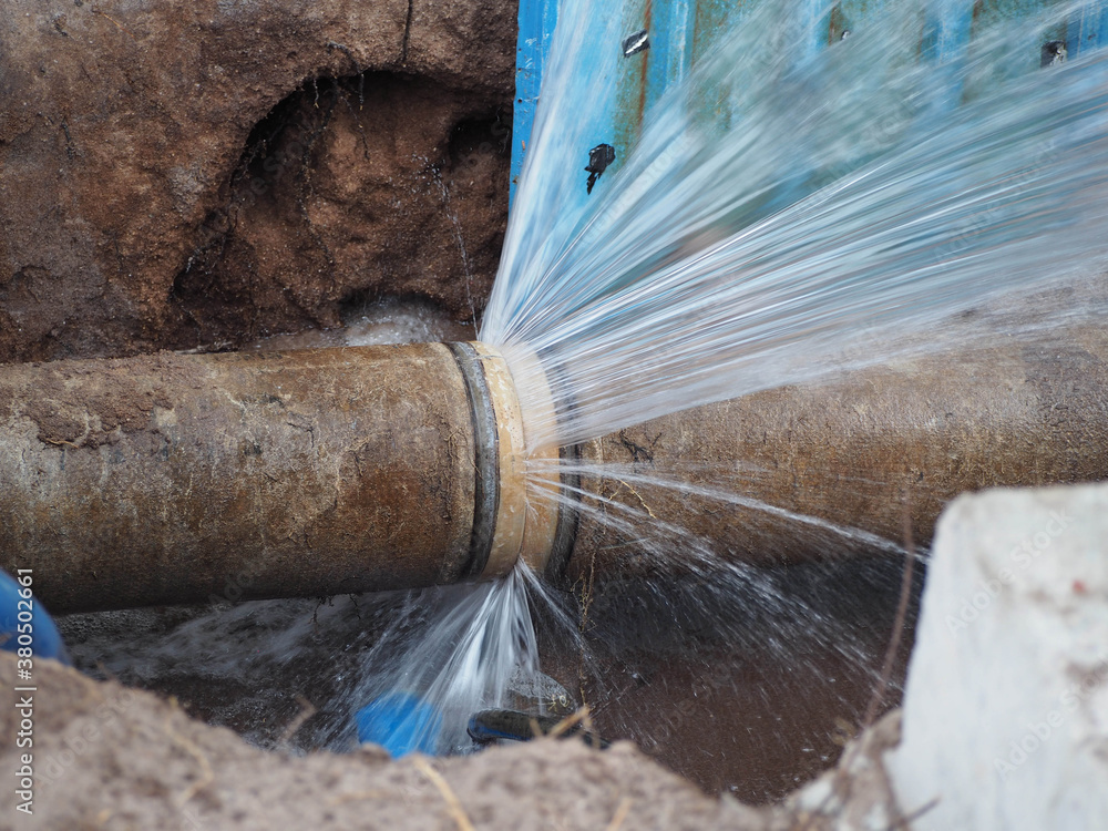 Burst pipe or leaking pipe is under repairing Stock Photo | Adobe Stock