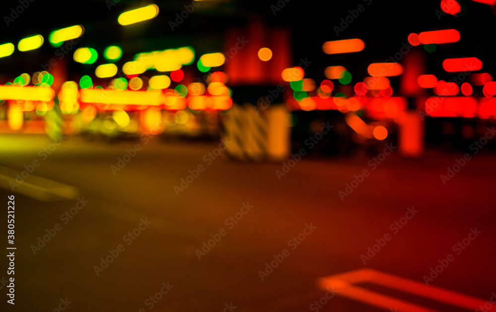 Blurred cars in car parking lot in shopping mall. Bokeh lights ...