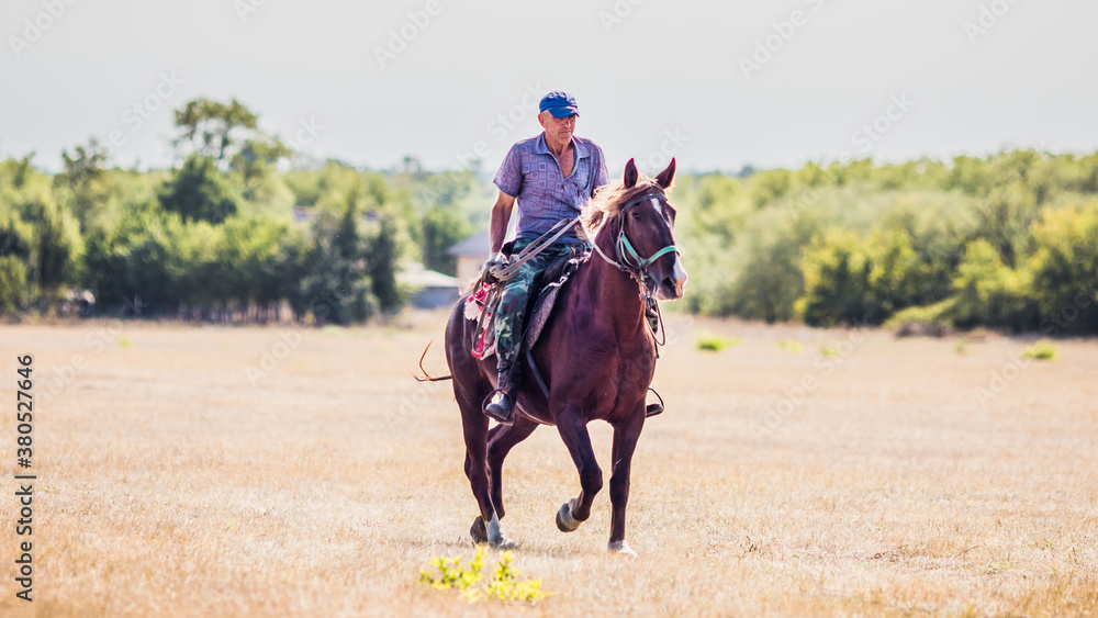 Old man rides a horse along the road in Russia Stock Photo | Adobe Stock
