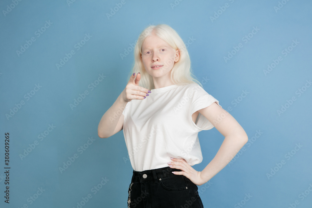 Pointing, choosing. Close up portrait of beautiful caucasian albino ...