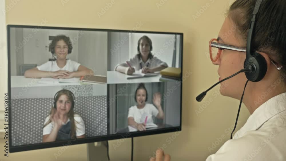 Teacher leads a video lesson for four students. Features of distance ...