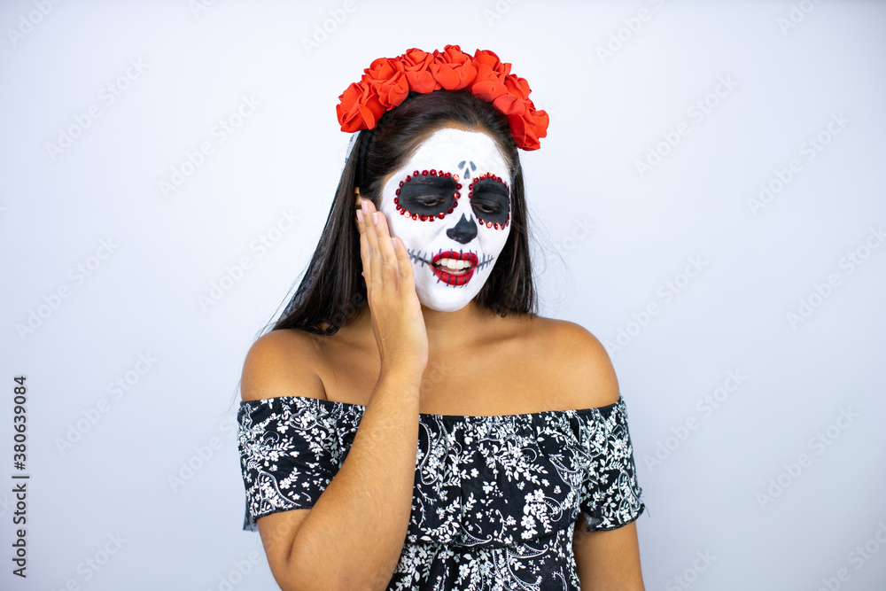 Woman wearing day of the dead costume over isolated white background ...
