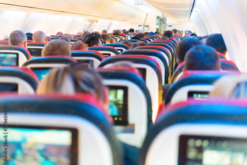 People flying sitting in plane interior with multimedia screens Stock ...