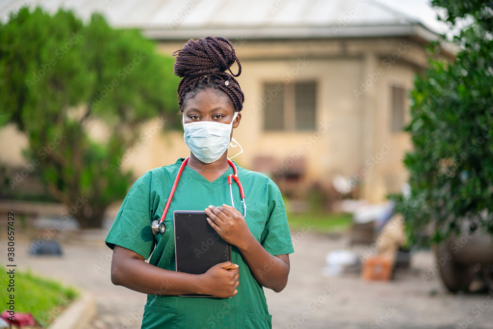 image of black nurse with face mask-young African health worker holding ...