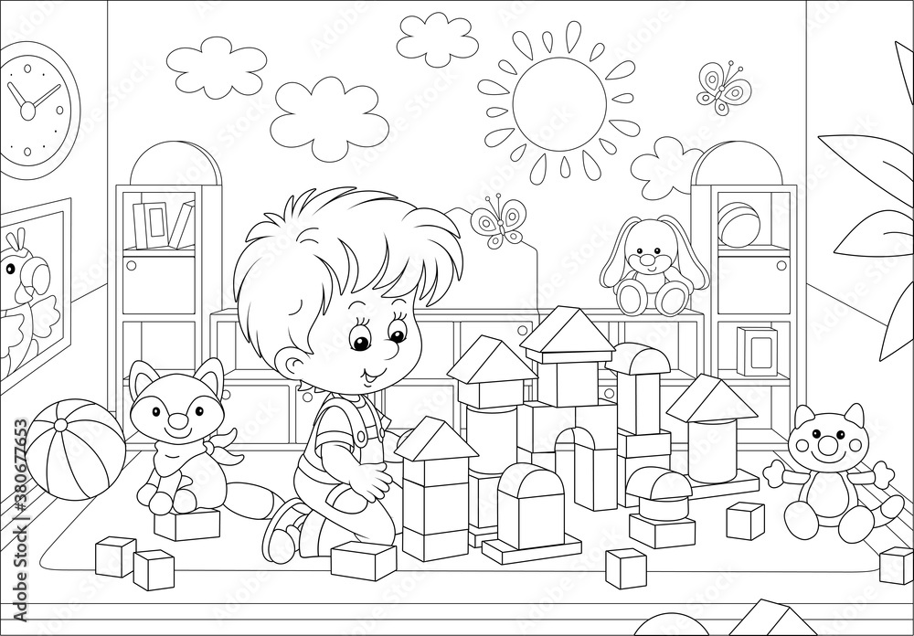 Happy little boy playing with bricks and constructing a funny toy ...