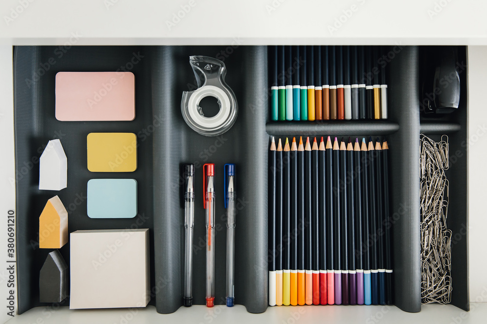 Office supplies in desktop drawer. Writing pens, pencils, paper clips ...