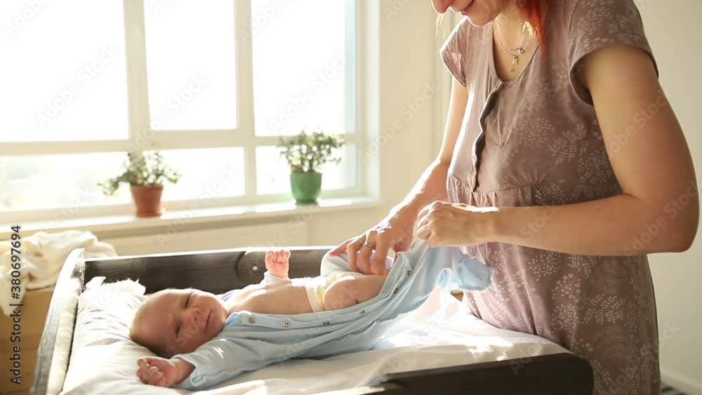Mother changing clothes of her little baby Stock ビデオ | Adobe Stock
