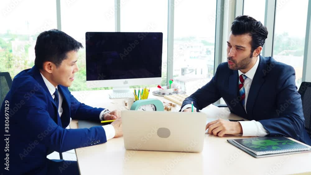 Two business people talk project strategy at office meeting room ...