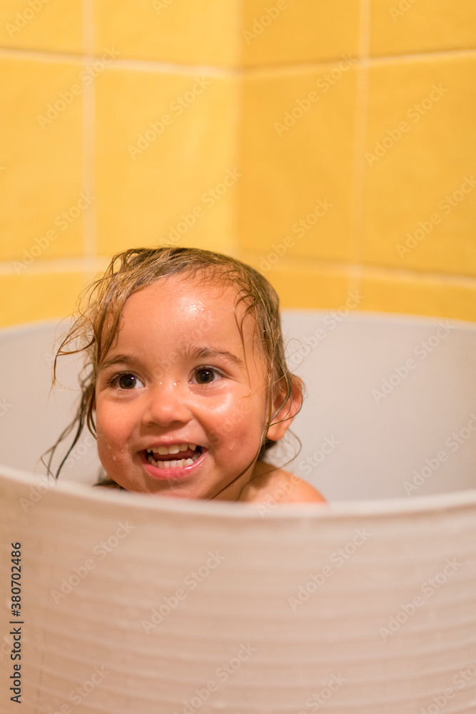 Baby girl having a bath in a bucket Stock Photo | Adobe Stock