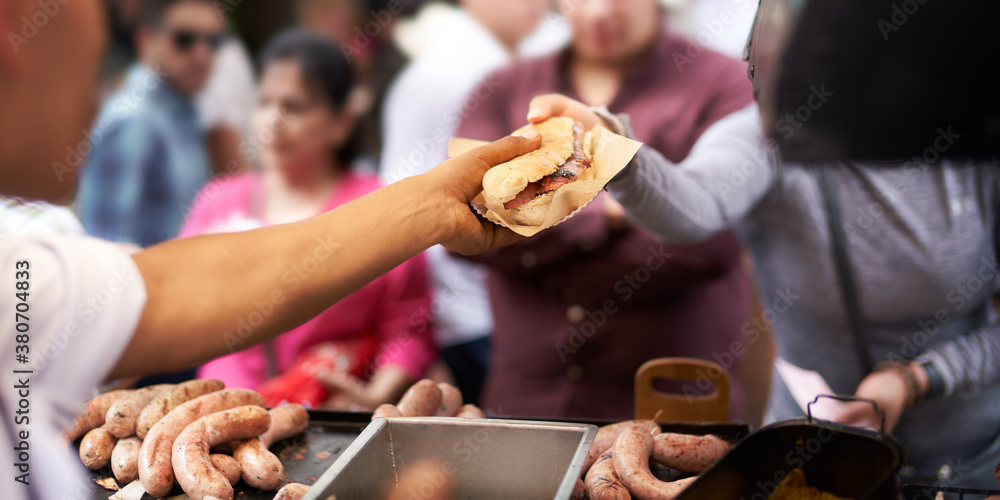 Cook selling sandwich to customer at street food stall Stock Photo ...