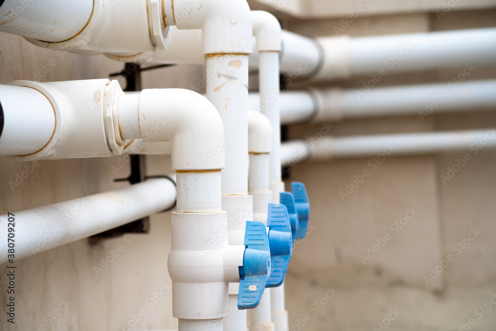 White PVC pipes with cool blue taps, valves and cocks that stand out ...