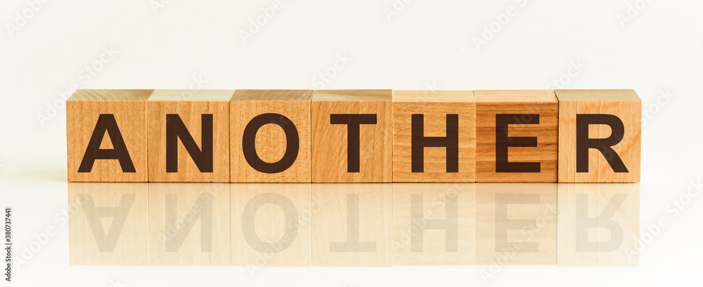 ANOTHER, word in 3d wooden alphabet letters isolated on white ...