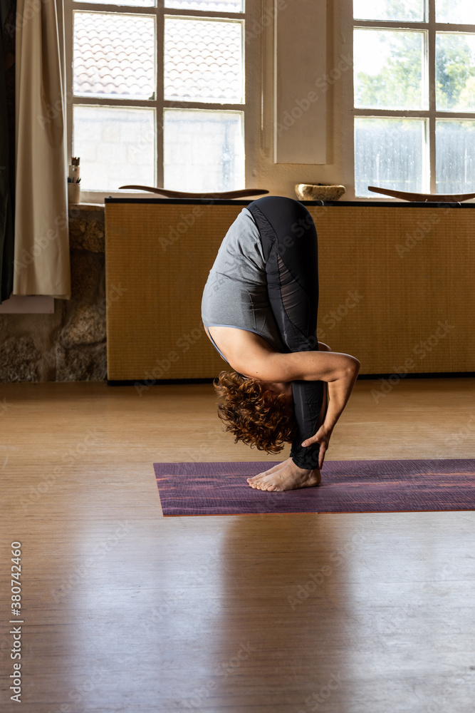 Full body side view of unrecognizable female in sportswear performing ...
