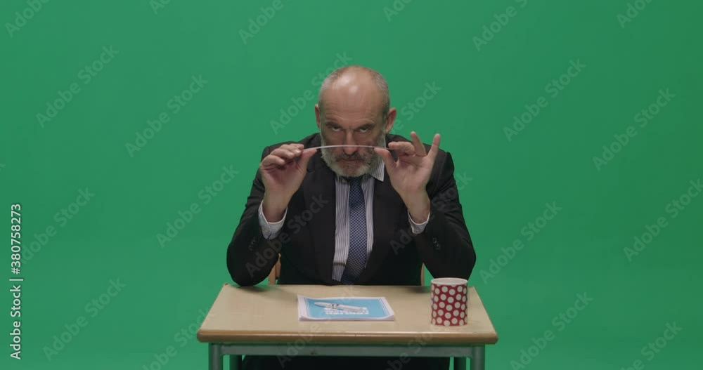 Studio, slow motion, green screen, a frustrated mature teacher pretends ...