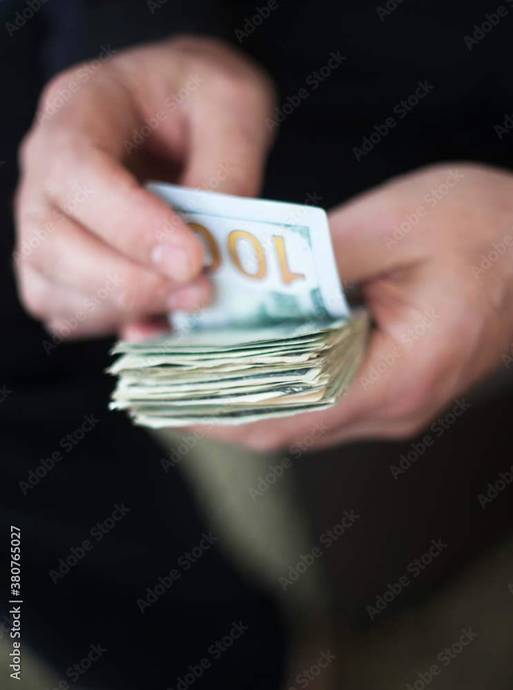 Man's hands counting a stack of cash - the new hundred dollar bill at ...