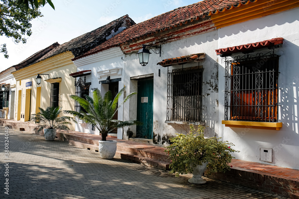 Typical historic houses in warm afternoon light, trees and river, Santa ...