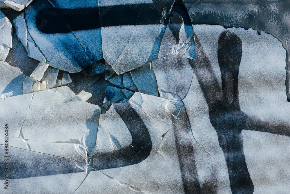 Spray painted graffiti on broken glass window of building exterior ...