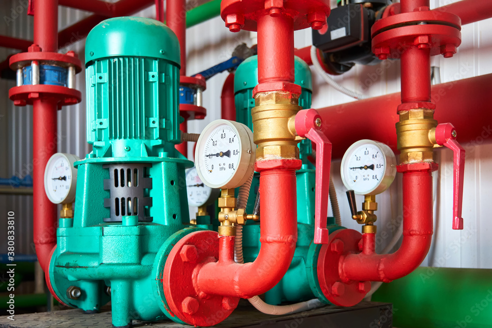 Green electric motor with a pump on the hot water supply line with ...