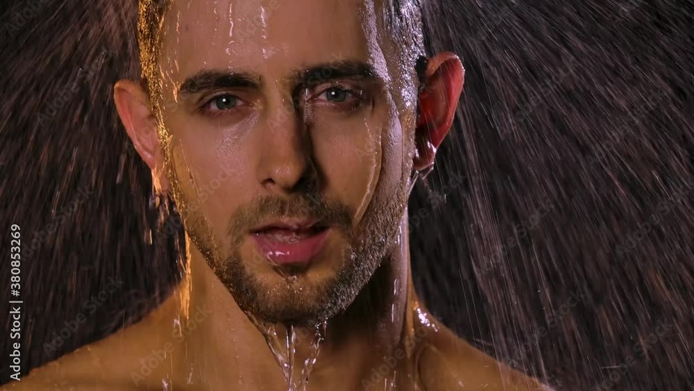 Portrait Of A Sexy Young Man Under Shower Jets Who Looks Erotically Into The Camera Water Flows