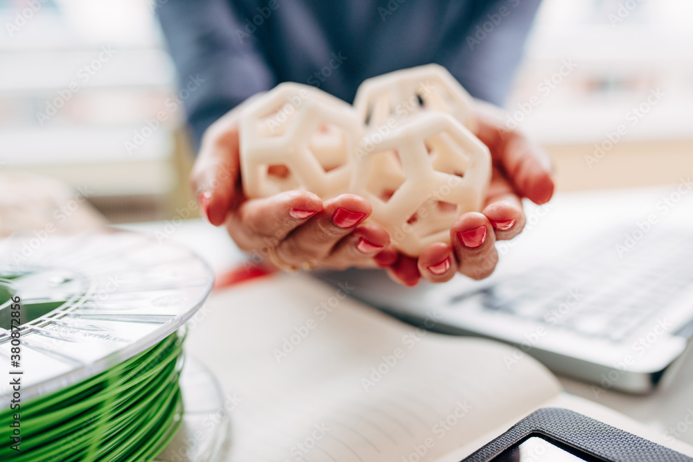 Engineer holding and inspecting 3d printed hexagon design samples Stock ...
