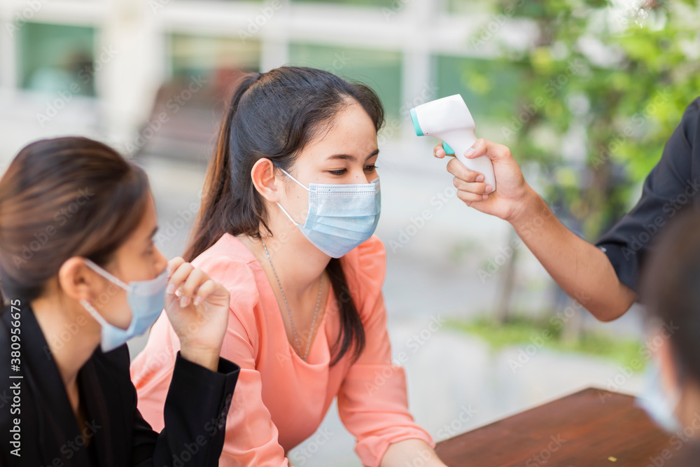 Group of asian students in school building checked and scanned for ...
