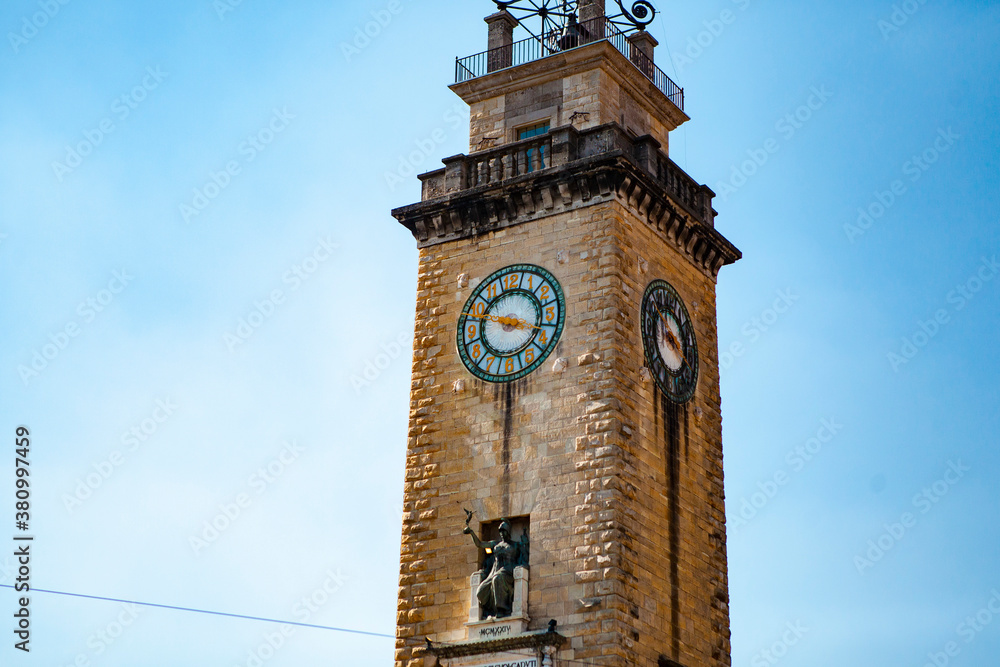 Foto de Close up. The tower of the vintage Italian cathedral made of ...
