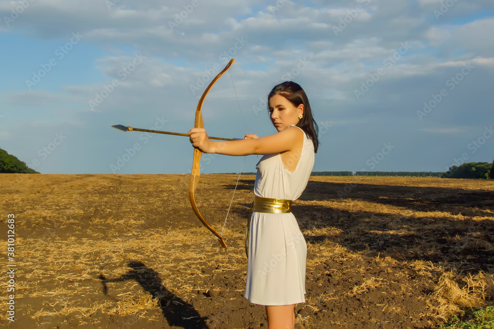 portrait of a young beautiful woman in a white tunic with a Golden belt ...