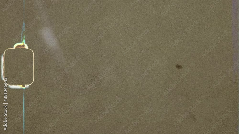 Vintage-style flicker Super 8 film moves across the top with gear holes ...