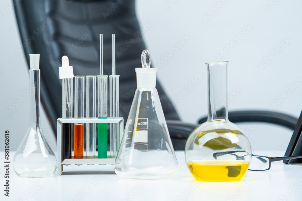 Transparent test tubes on background of empty chair. Laboratory glass ...