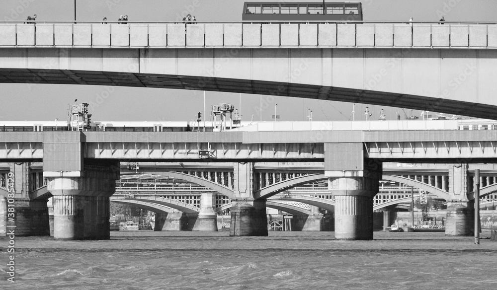 Bridges over River Thames in London, England with pedestrians, trains ...