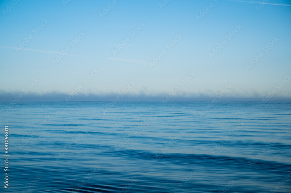ocean with light waves in bright blue as a conceptual background with a ...