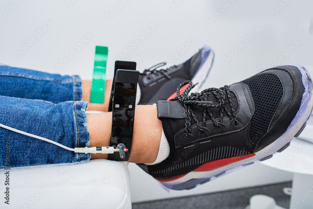 ECG electrodes on male leg. Electrocardiogram in a hospital room ...