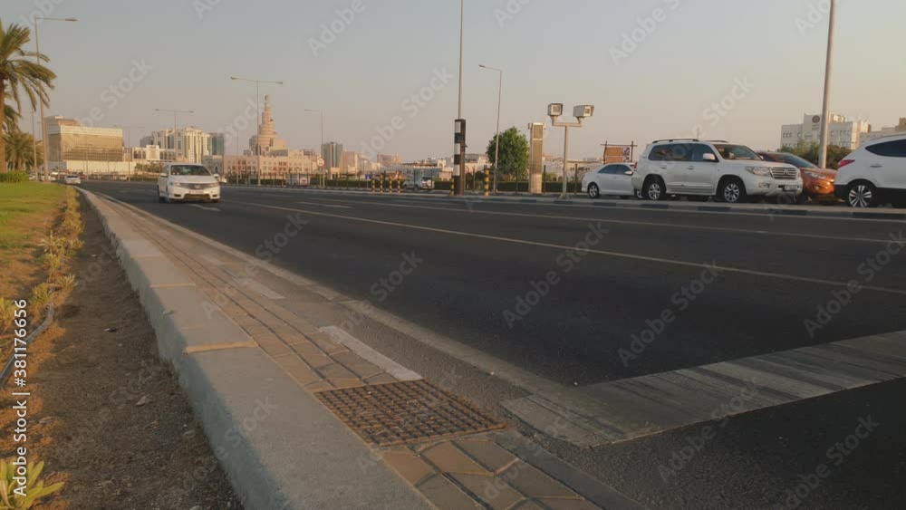 Corniche street in Doha Qatar afternoon low angle shot showing cars ...