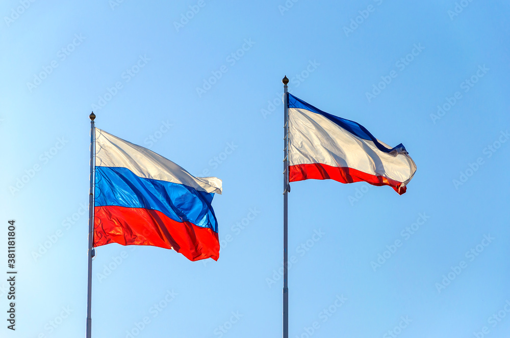 Flags of the Russian Federation and the Republic of Crimea on flagpoles ...
